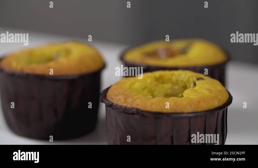 Baker stuffing muffins with bananas. Confectioner making banana cupcakes Stock Video Footage - Alamy