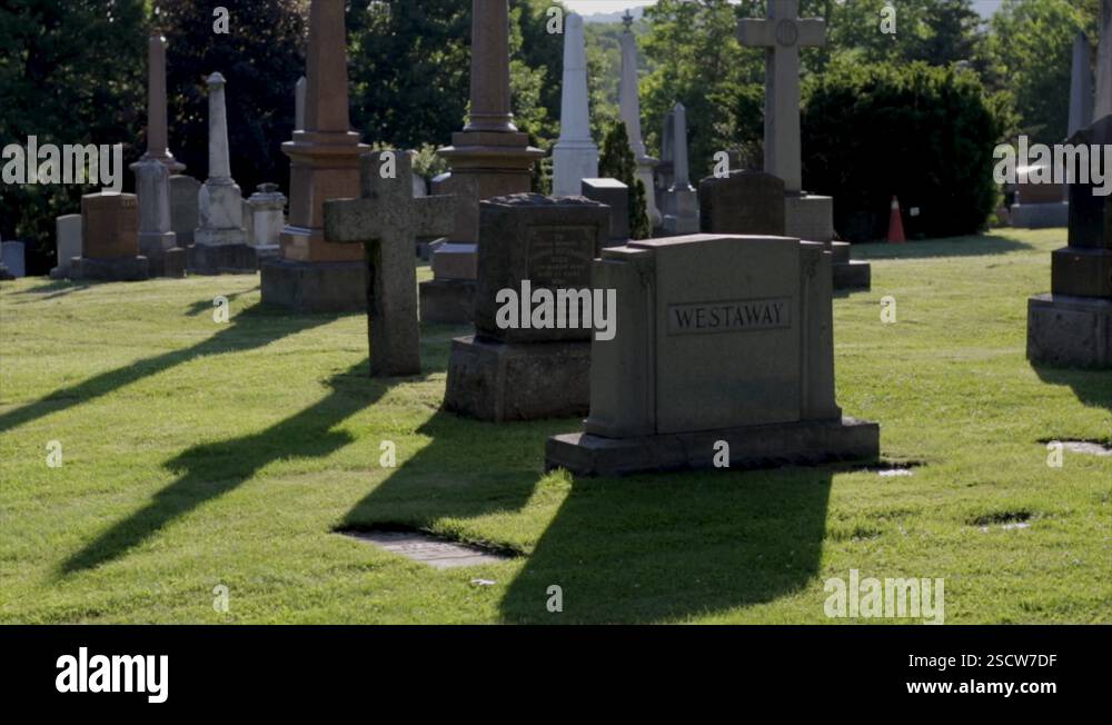 Old cemetery head stones at sunset. Graveyard with tombstones and ...