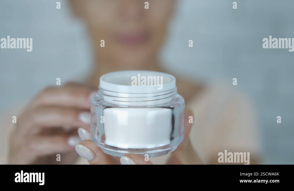 Apply face cream Stock Video Footage - Alamy