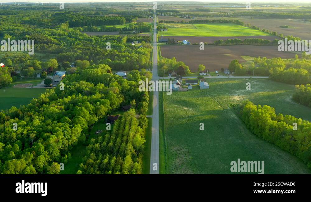 Flying down country road with textured fields and beautiful farms Stock ...
