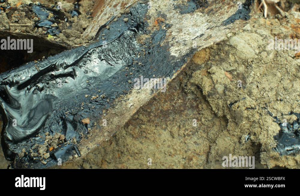 Tar asphalt toxic chemical in detail and closeup clay. Former dump ...