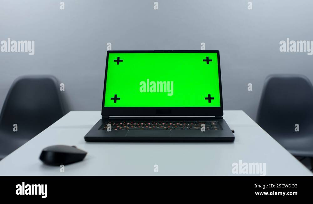 Laptop with a green screen (chroma key) and tracking markers. Bright ...