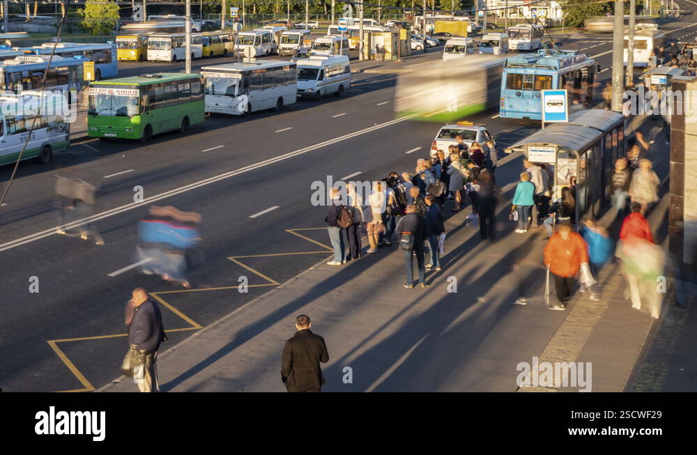 passengers waiting and boarding buses at the bus terminal, time lapse ...