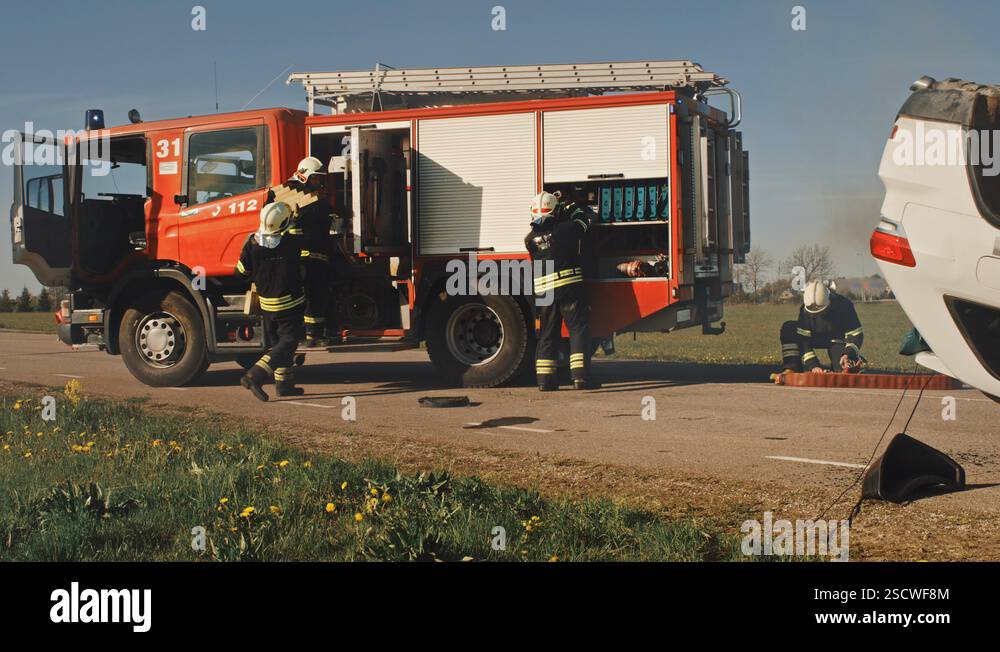 Firefighters Arrive on the Car Crash Traffic Accident Scene on their ...