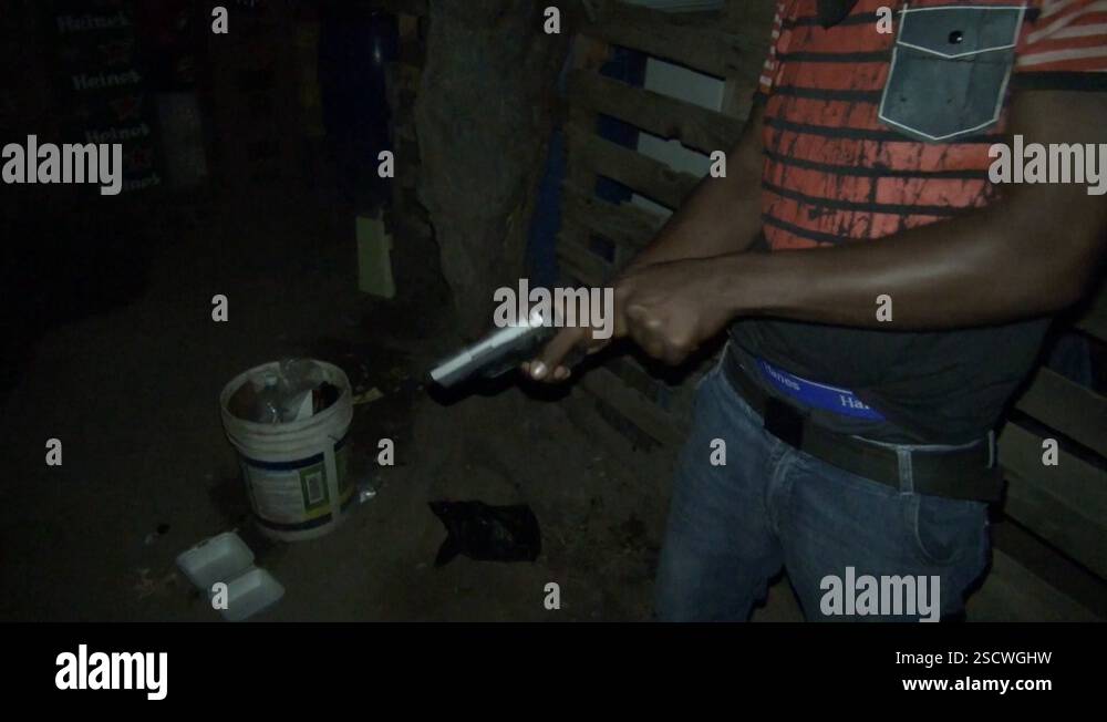 KINGSTON, JAMAICA : Jamaican young gang holding hand gun with bullet ...