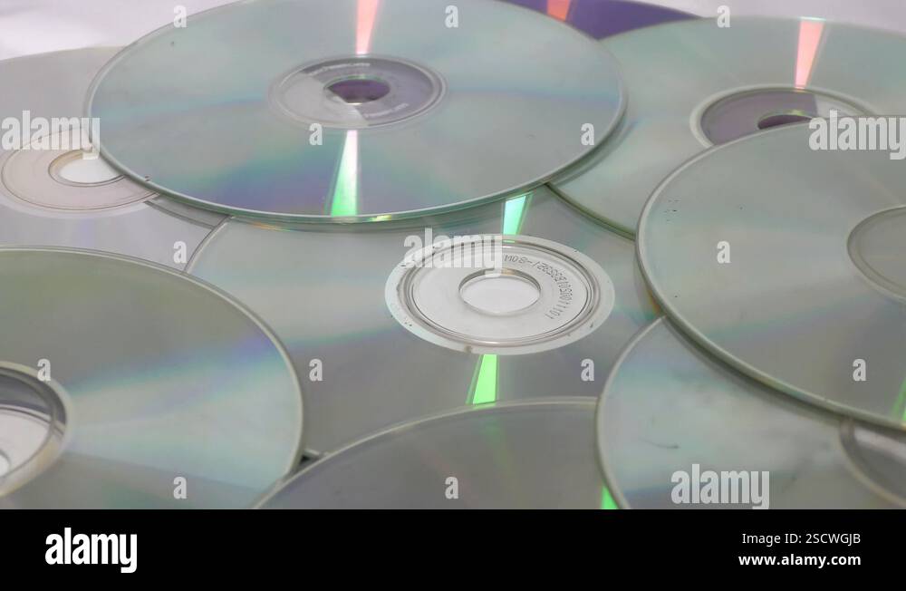 Old cds and dvds moving in circular motion on white surface Stock Video ...
