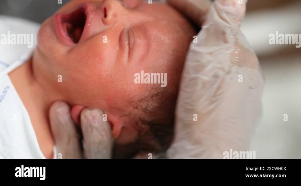 Newborn baby taking a bath at hospital after birth crying Stock Video ...