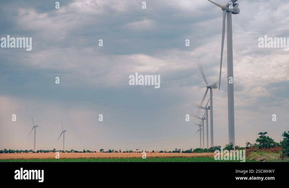 Windmill turbine generating clean renewable energy in green ...