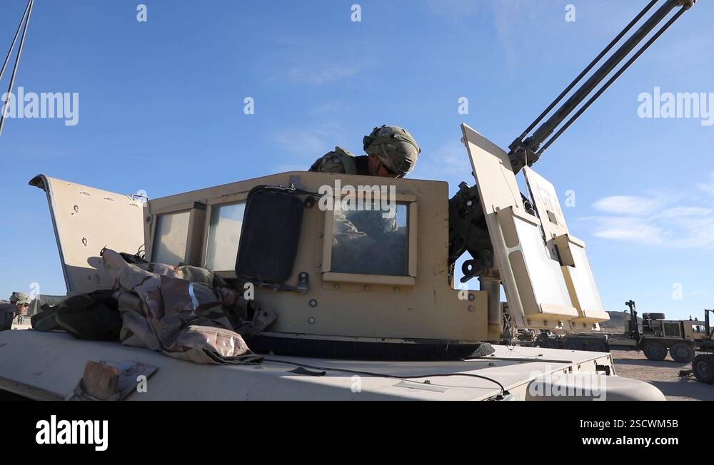 Soldier securing weapon on up-armored Humvee for transportation Stock ...