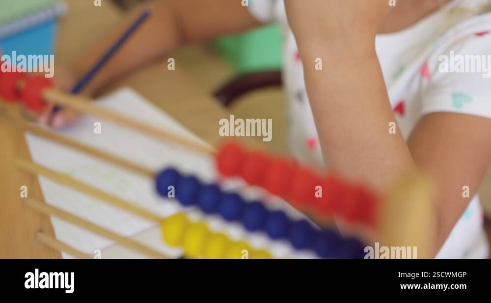 Girl learning mathematics on abacus at table in a comfortable home 4k ...
