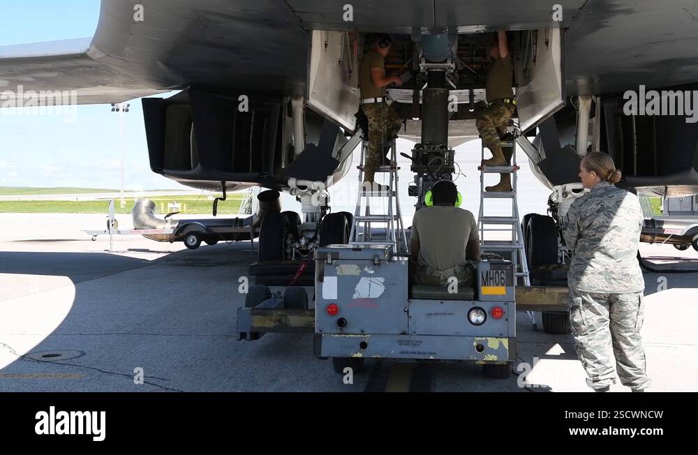 Munitions airmen loading bomb into B2 Lancer with bomb loader Stock ...