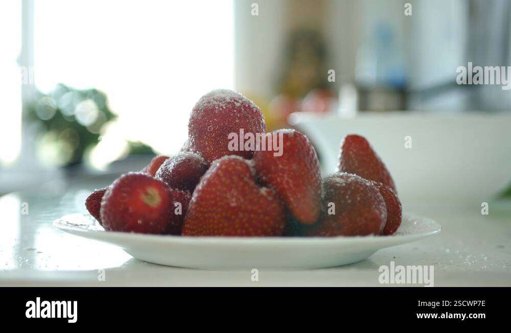 Man Hand Put White Sugar Over a Plate Full with Red Strawberry Fruits ...