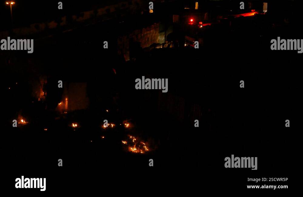 Aerial top view of firefighters with fire engine extinguish fire at ...