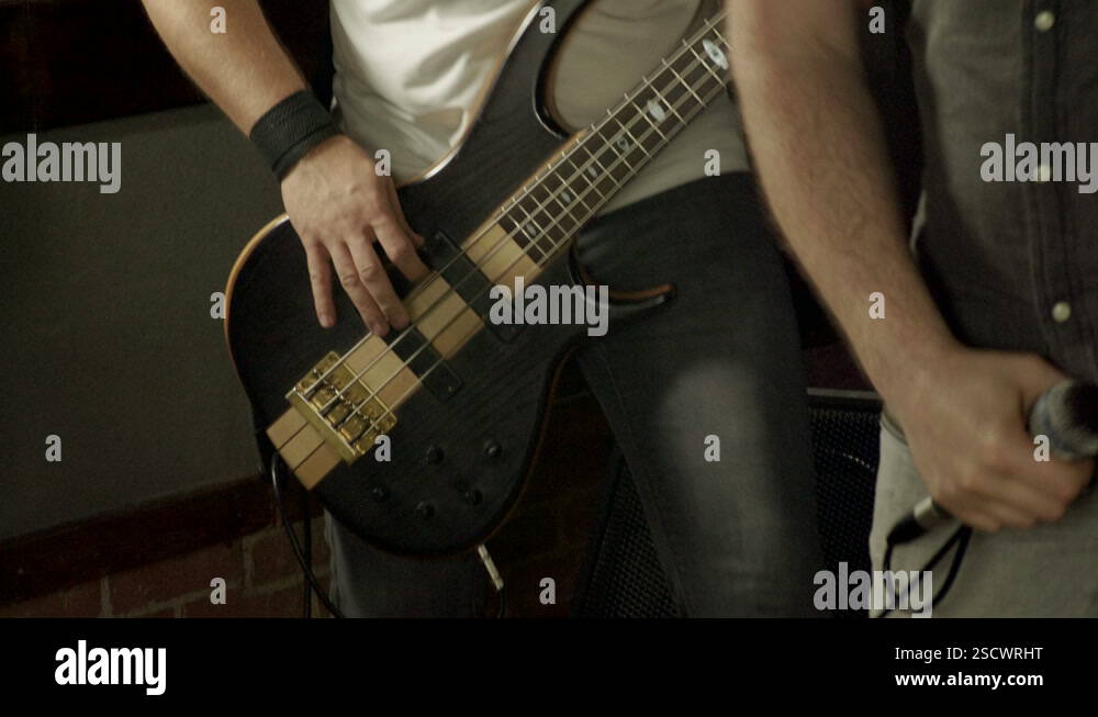 Musical metal band. Group of musicians playing rock music on stage. 4K ...