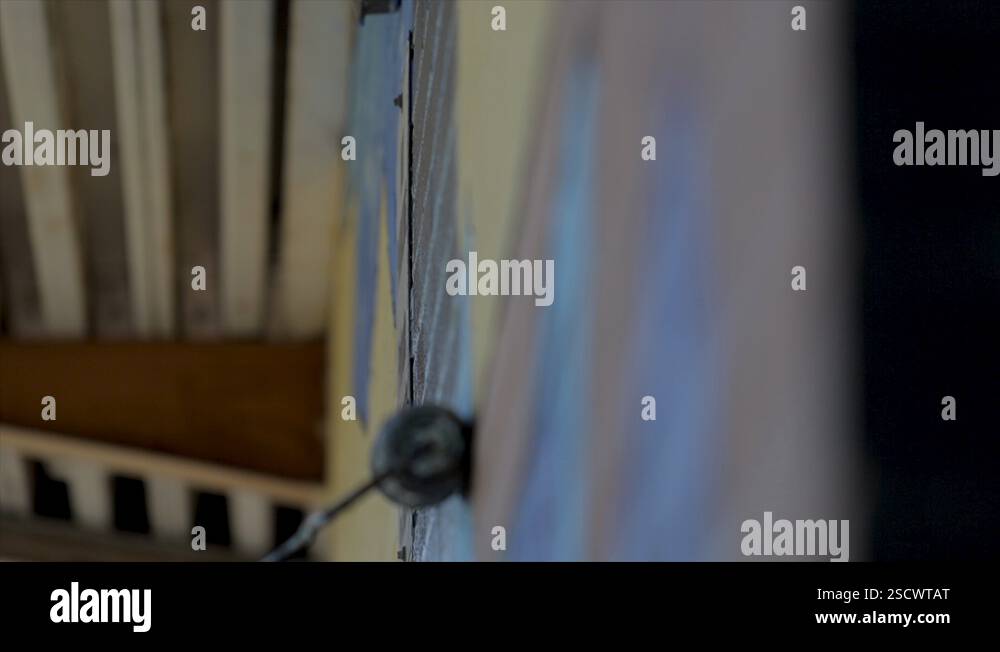 Painting over graffiti with a roller on a stick. Removing graffiti ...