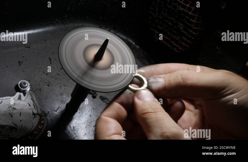 Buffing and shining a gold diamond ring using a polishing disk Stock ...