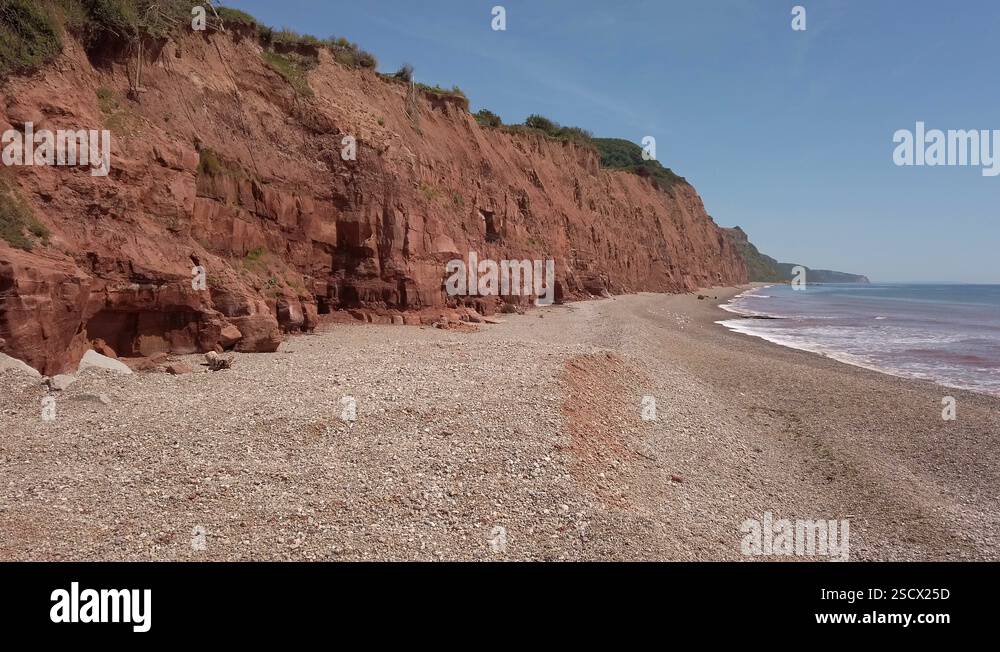 Red cliffs on the Jurrasic coast at Sidmouth Devon England Stock Video ...