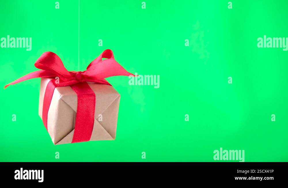 Gift box with red ribbon spinning on green screen. 360 degree rotation ...