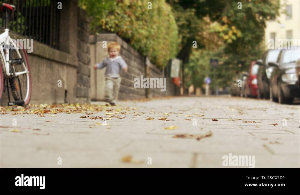 A boy running on the pavement Stock Video Footage - Alamy