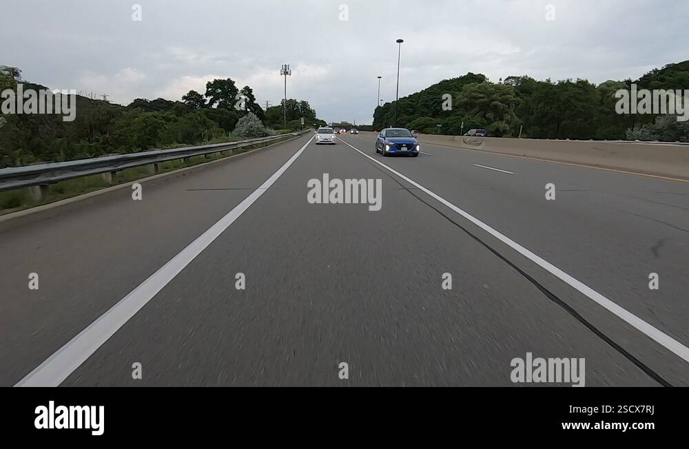 Driving plate reverse POV highway driving with cars and trucks traffic ...