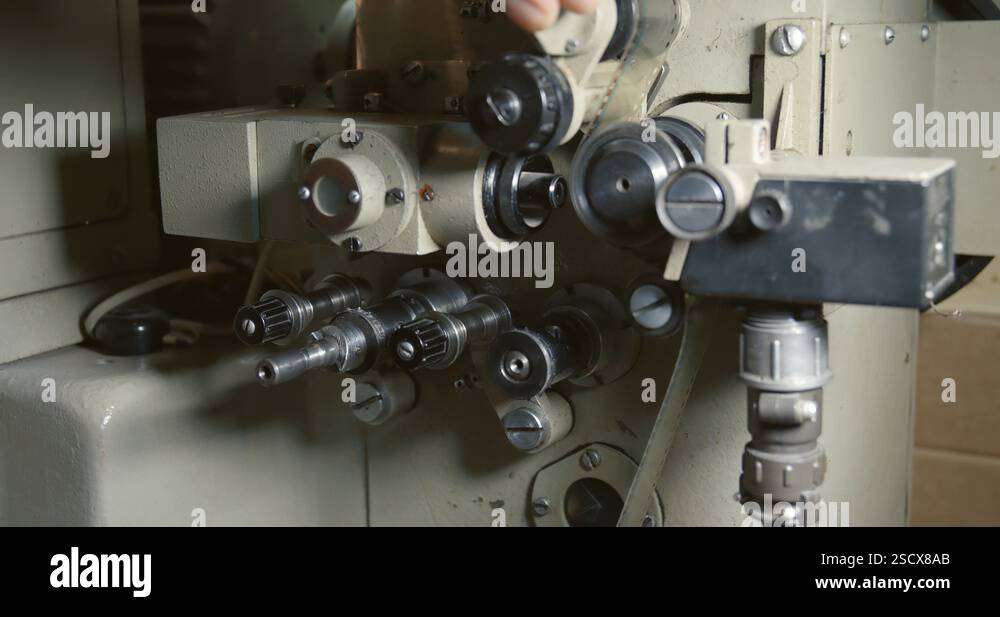 Placing 35mm cine-film roll in the mechanism of film projector Stock ...