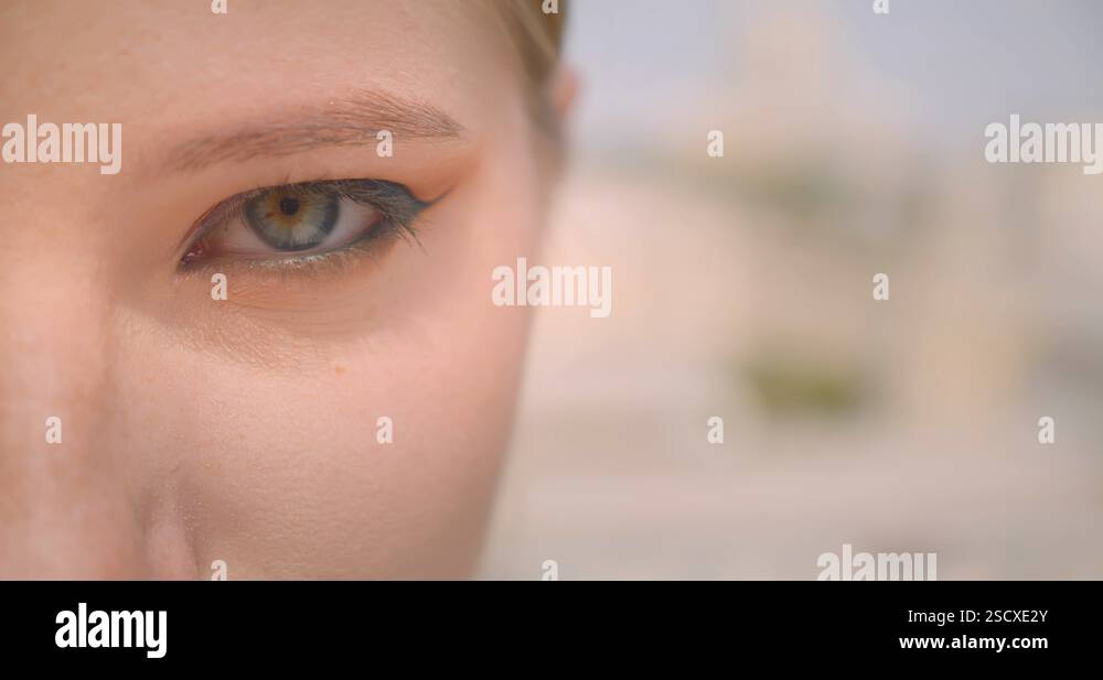 Closeup half face portrait of young caucasian female face rolling her ...