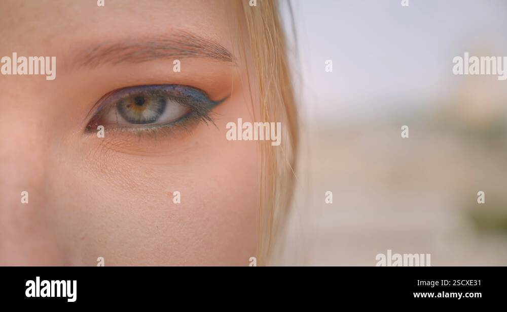 Closeup half face portrait of young seductive caucasian female face ...