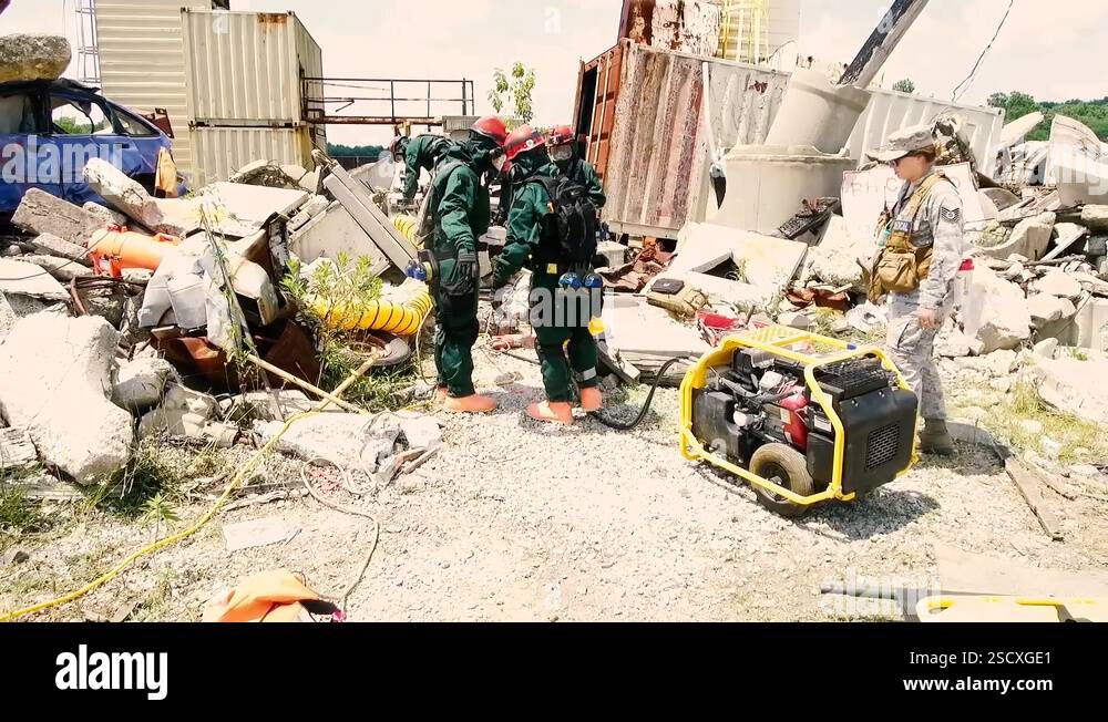 Soldiers wearing CBRN protective suits evacuating casualty on rescue ...
