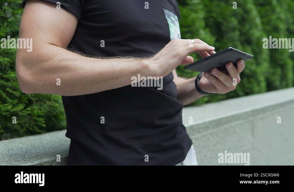 The guy uses the tablet on the street, only hands are visible Stock ...