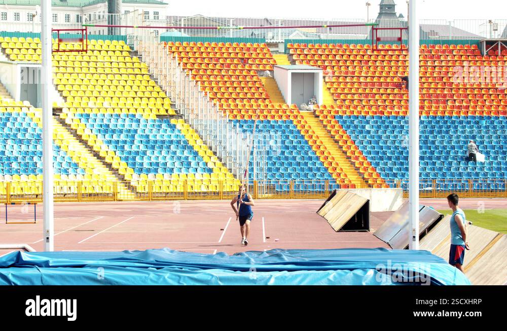Pole vault - an athletic man running up and rest against the ground on ...