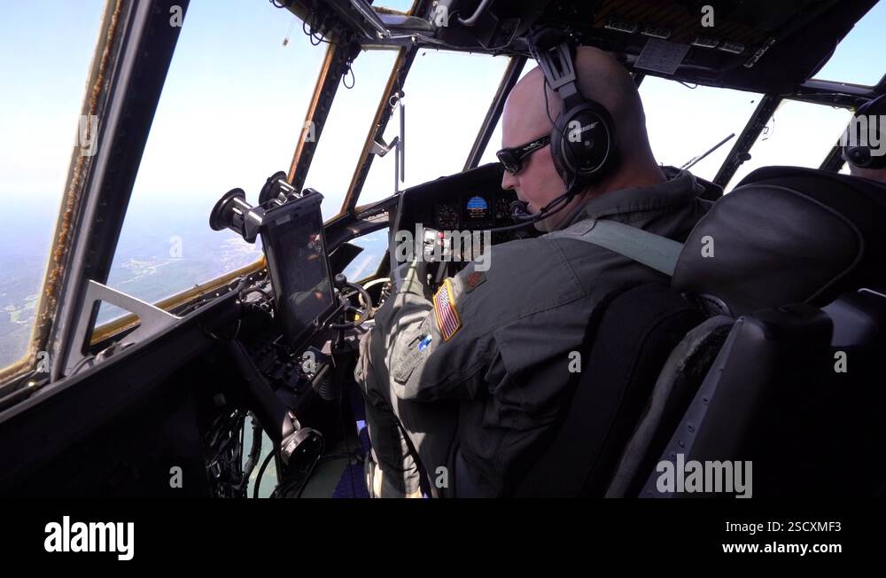 C-130 Hercules pilot relaying information from computer during flight ...