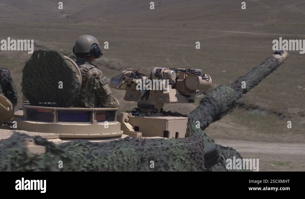 Gunner looking out from M1A1 Abrams hatch while travelling through ...