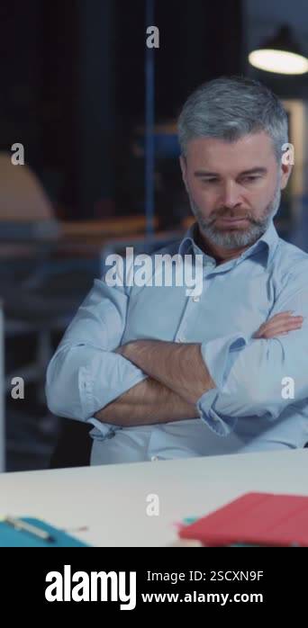 A contemplative man with gray hair engages in deep reflection while ...