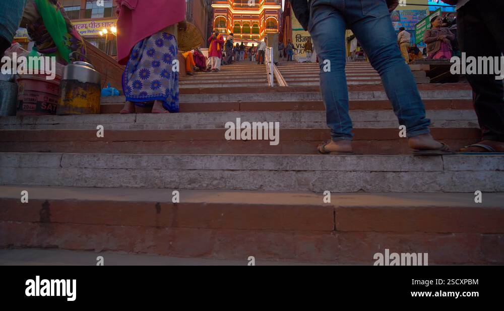 People resting on stairs of Hindu temple on Ganges river bank, Varanasi ...