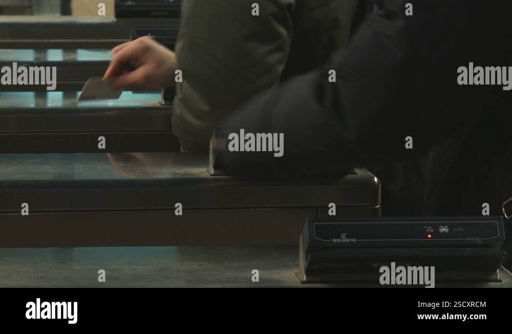 Stamp the card close up. Workers starting morning shift outside a ...