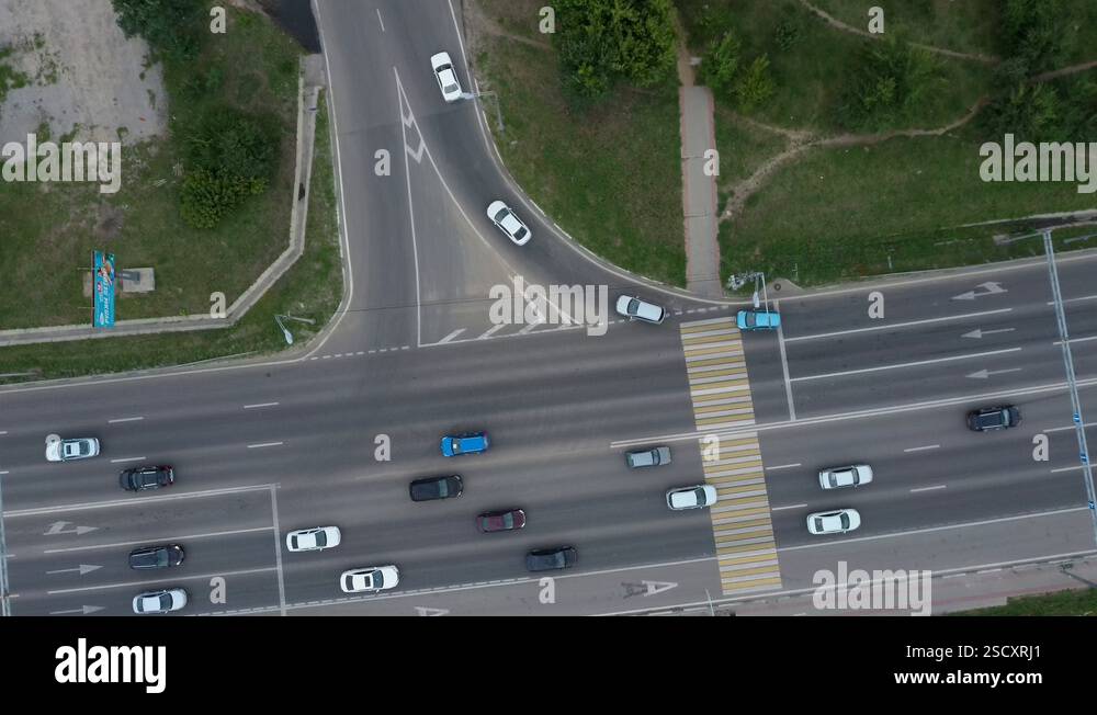 Cars are moving on the road in the city, two-way traffic. Aerial view ...