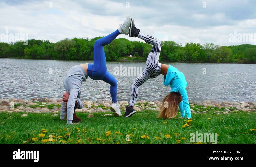 sporty ladies stand in bridge positions with raised legs Stock Video ...