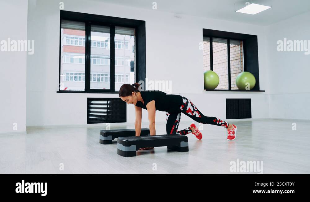 A woman does push-ups between step platforms and she does not succeed. The girl Stock Video ...