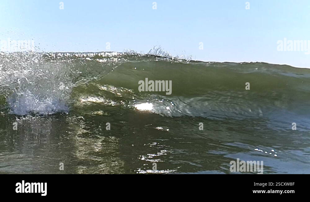 Big breeze waves close-up in slow motion, moving towards the shore. The ...