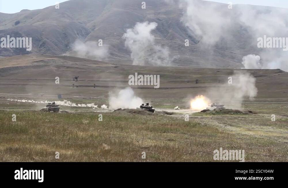 Three battle tanks fire cannons in unison at range in Georgia Stock ...