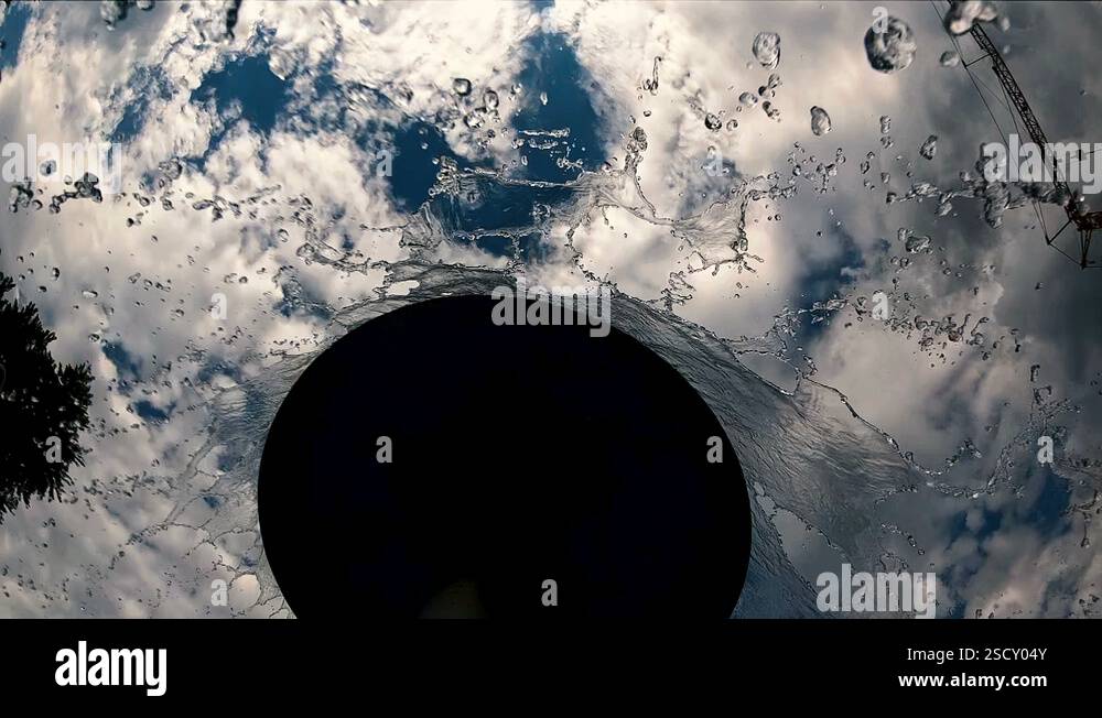 Water drops falling on the camera from luxury fountain in the swimming ...