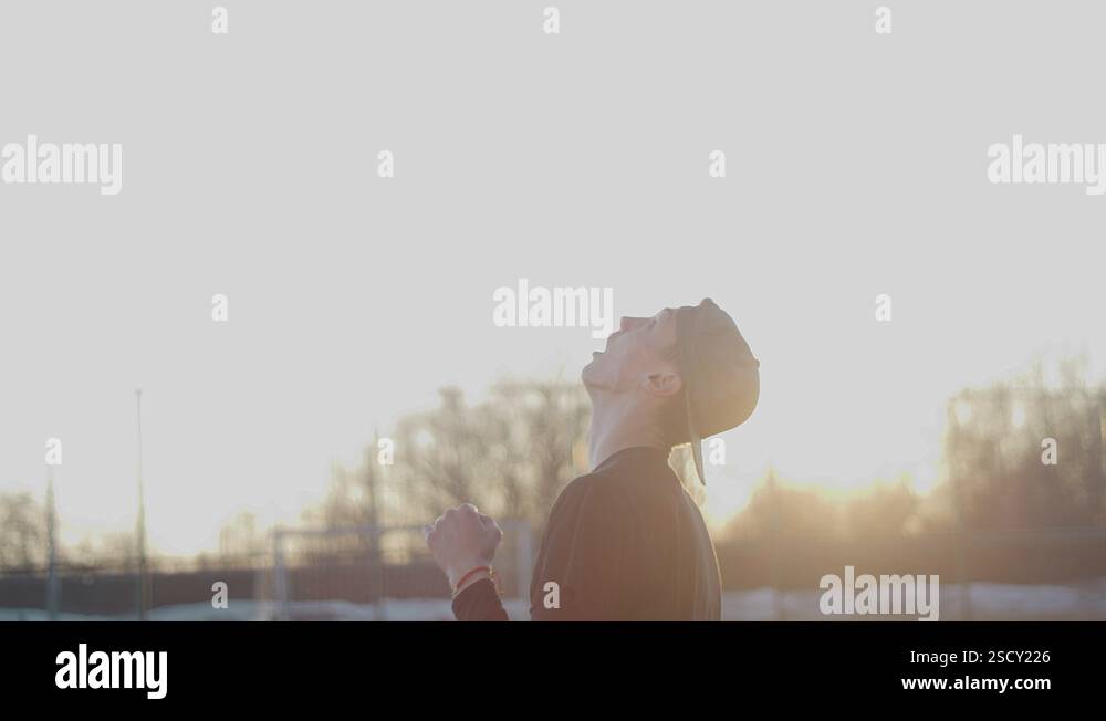 A young guy throws a football catches, beats his head. Street football ...