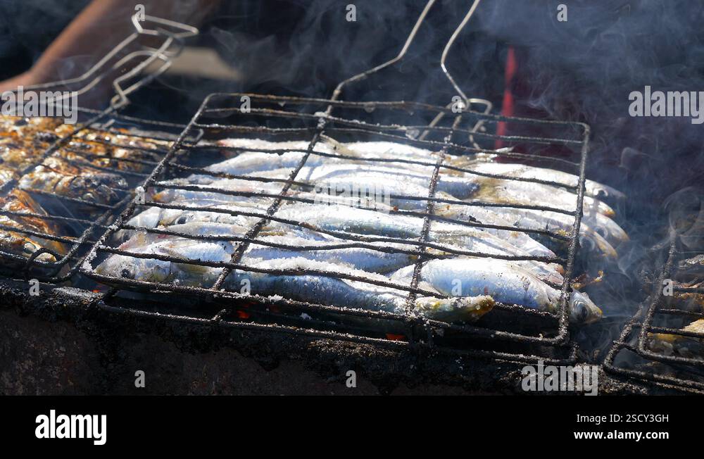 Fresh fish being grilled and roasted in open on street in Morocco ...