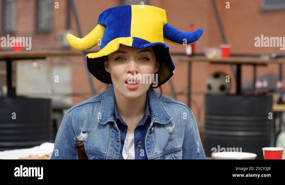 Excited Woman Holding Beer and Cheering for Team in Outdoor Sports Bar ...