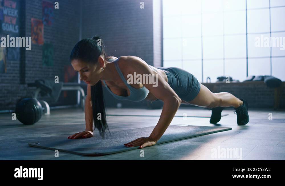 Strong and Fit Athletic Woman in Sport Top and Shorts is Doing Push Ups ...
