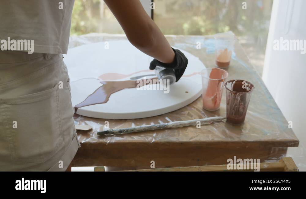 girl working with acrylic paints in a creative studio, the process of ...