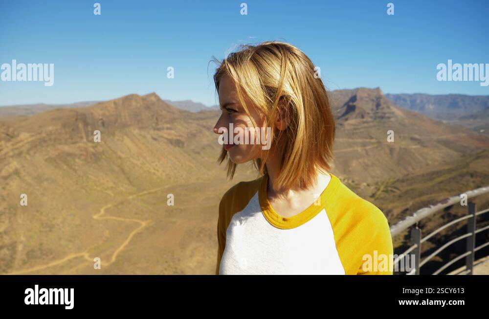 Model Looking Sideways Looking at View with Hair Brushing Her Face in ...
