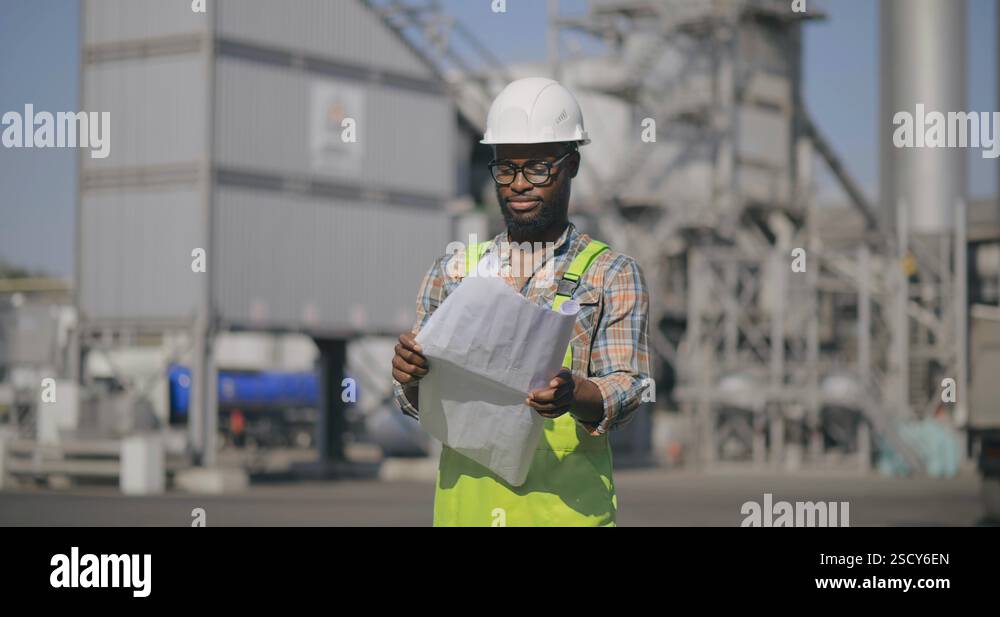 African constructor with blueprint Stock Video Footage - Alamy