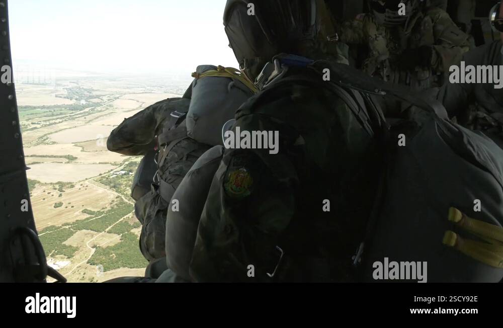 U.S. and Bulgarian army parachutists jumping from UH-60 Black Hawk ...