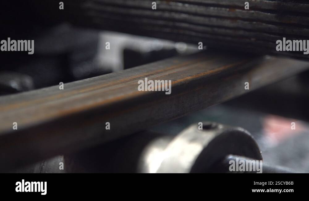 metal pin passes through an old bending machine in a workshop. close-up ...